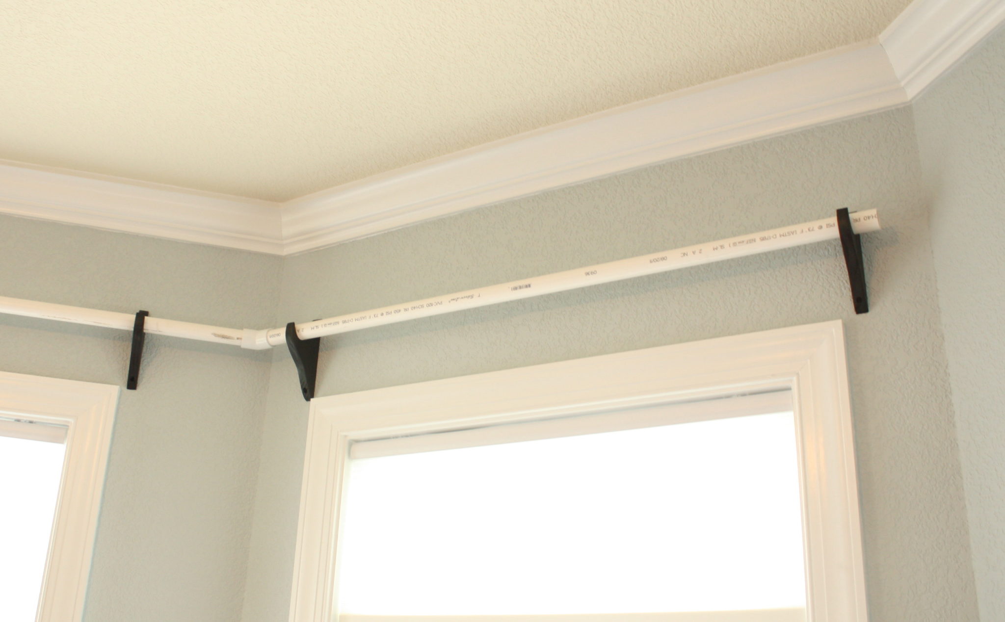 She spent $20 to make stylish curtain rods from PVC pipes