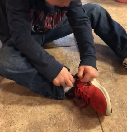 Young Boy Demonstrates Shoe Tying Trick