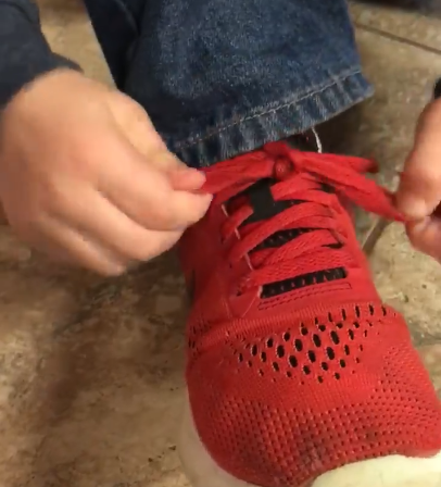 Young Boy Demonstrates Shoe Tying Trick