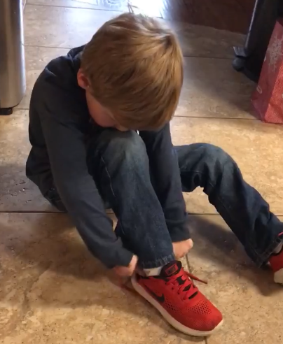 Young Boy Demonstrates Shoe Tying Trick