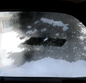 Man uses strips of painter’s tape to show how to easily defog car windows