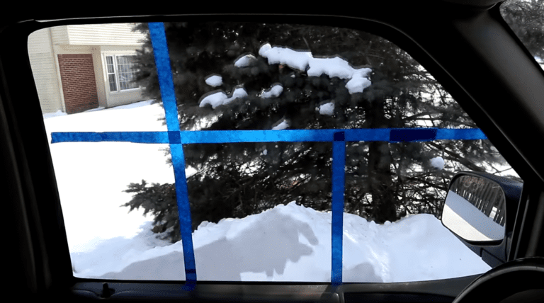 Man uses strips of painter’s tape to show how to easily defog car windows