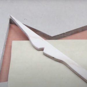 Woman uses tick stick to demostrate old carpentry hack for copying patterns