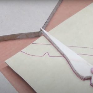 Woman uses tick stick to demostrate old carpentry hack for copying patterns