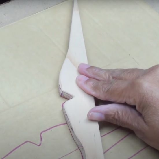 Woman uses tick stick to demostrate old carpentry hack for copying patterns