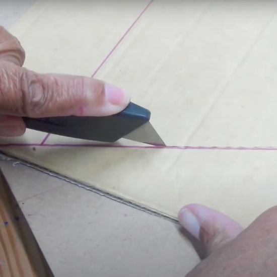 Woman uses tick stick to demostrate old carpentry hack for copying patterns