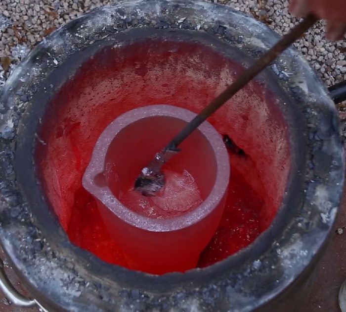 Man pours molten metal into a seashell to create a stunning piece of art