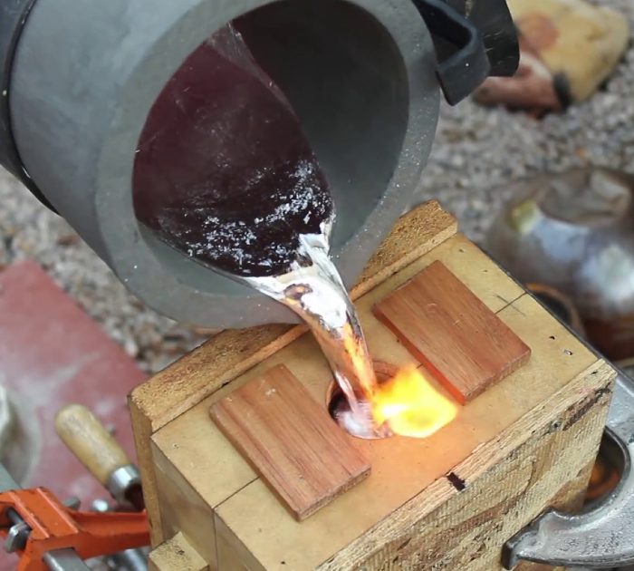 Man pours molten metal into a seashell to create a stunning piece of art