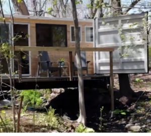 Man builds genius home out of shipping container that sits over a stream