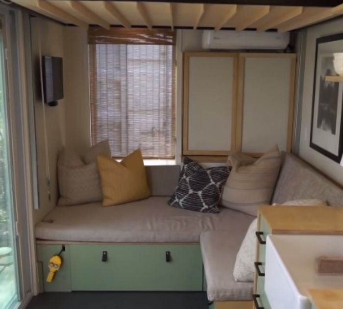 Man builds genius home out of shipping container that sits over a stream
