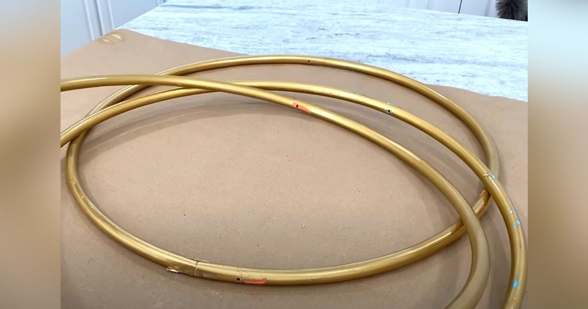 Woman covers 3 hula hoops in gold paint for fairytale garden idea