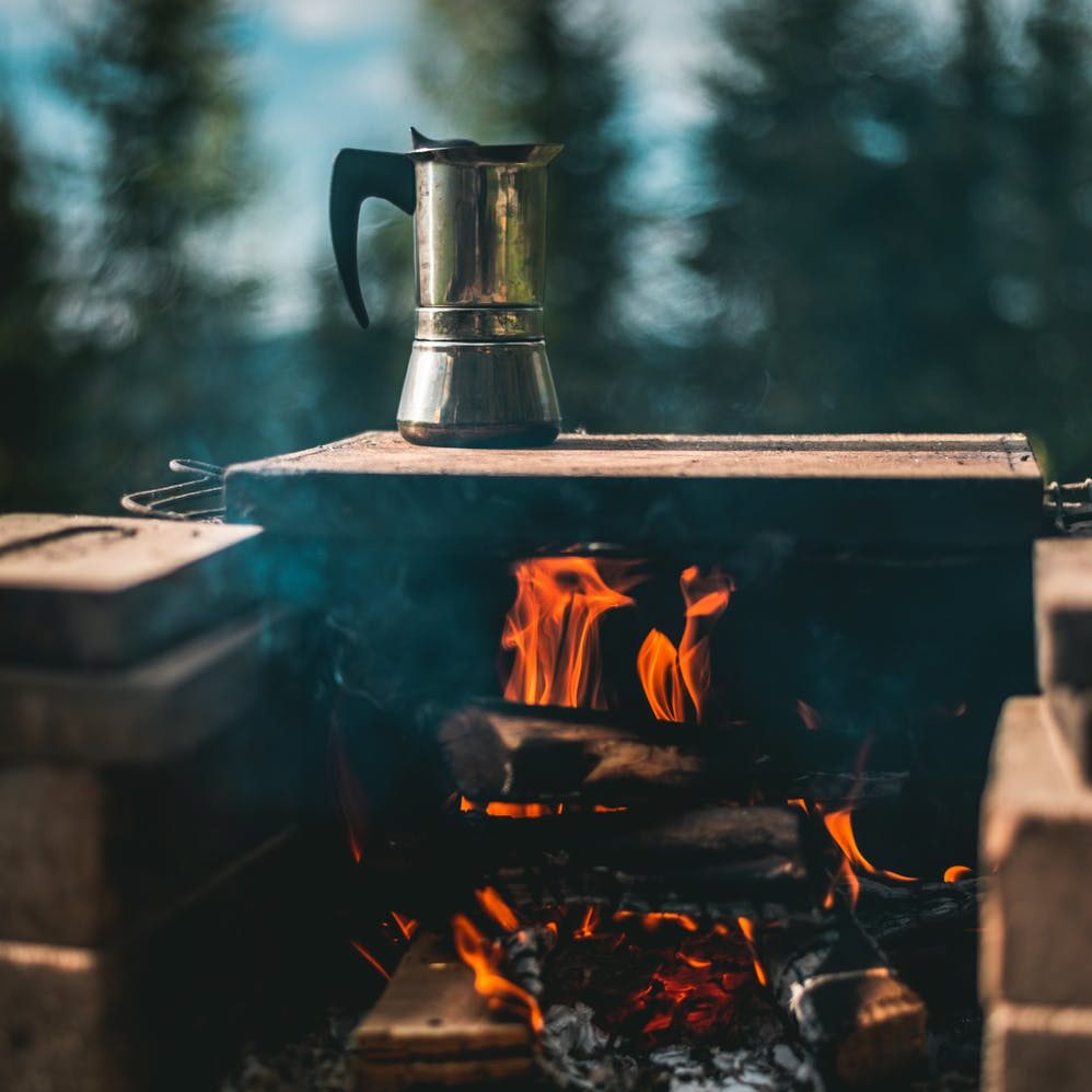 Man uses cement and two buckets to create smokeless outdoor stove