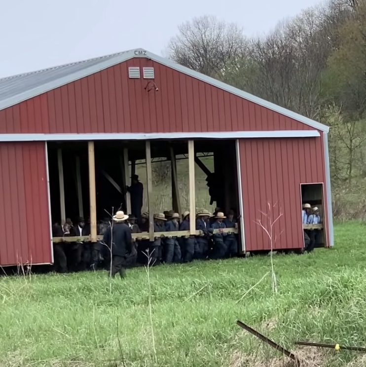 Hundreds of Amish men use their bare hands to lift barn and bring it to ...
