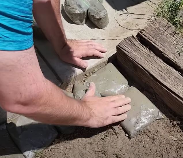 Guy lays baggies of concrete in his yard for gorgeous DIY garden feature