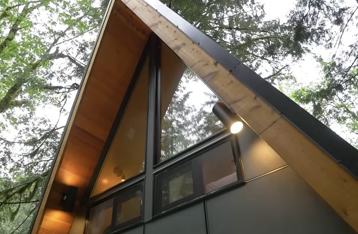 Man builds A-frame cottage wedged up in the trees for beautiful experience