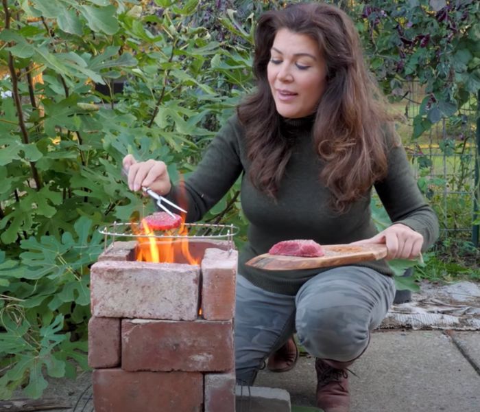 Homesteader stacks old bricks to make simple outdoor cook stove