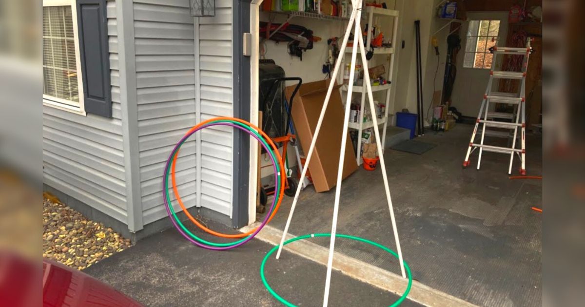 Man stacks hula hoops over teepee made of PVC pipes for a different ...