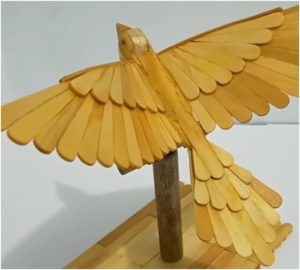 Man uses glue and popsicle sticks to make beautiful flying bird ornaments