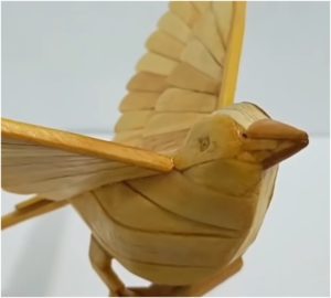 Man uses glue and popsicle sticks to make beautiful flying bird ornaments