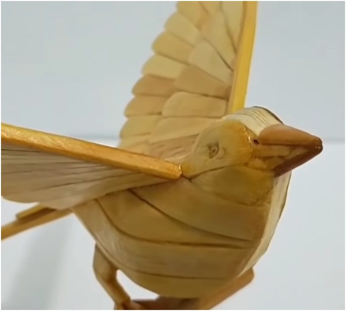 Man uses glue and popsicle sticks to make beautiful flying bird ornaments