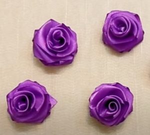 Fold layers of ribbon over needle to make adorable ribbon roses