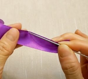 Fold layers of ribbon over needle to make adorable ribbon roses