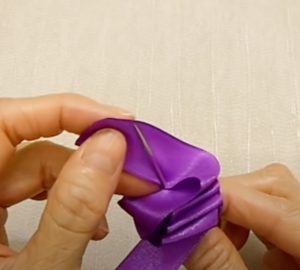 Fold layers of ribbon over needle to make adorable ribbon roses