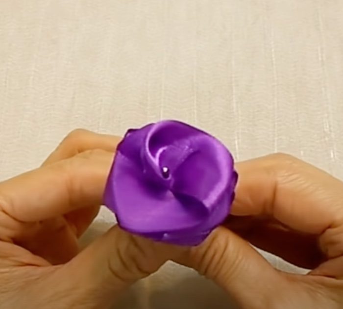 Fold layers of ribbon over needle to make adorable ribbon roses