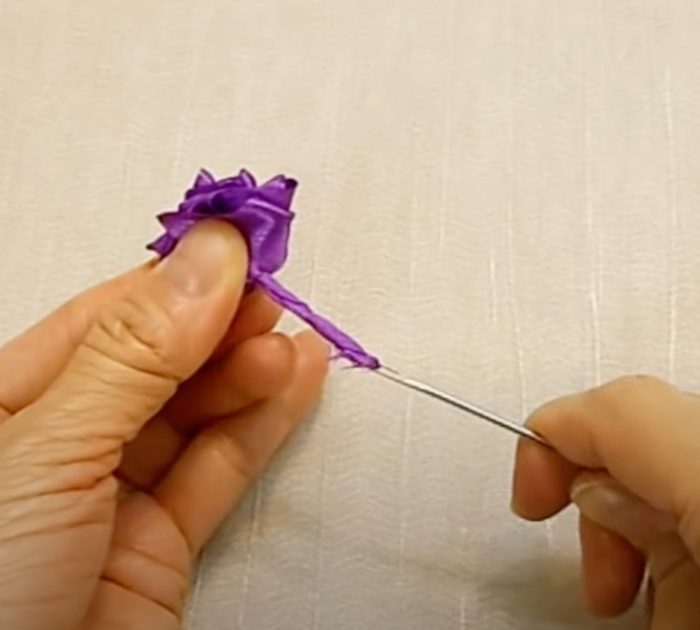 Fold layers of ribbon over needle to make adorable ribbon roses
