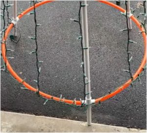 Man stacks hula hoops over teepee made of PVC pipes for a different ...