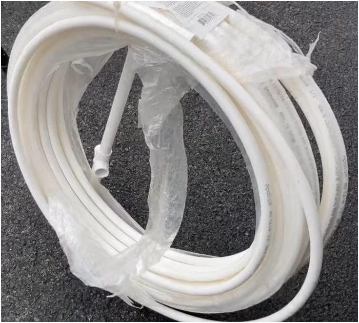 Man stacks hula hoops over teepee made of PVC pipes for a different ...