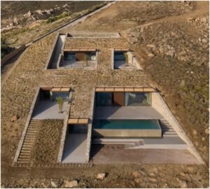 Underground house built into hillside has interior straight out of magazine