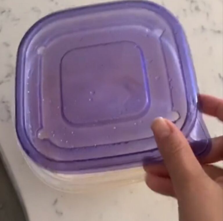 Young woman shows how to get grease stains out of Tupperware with ...