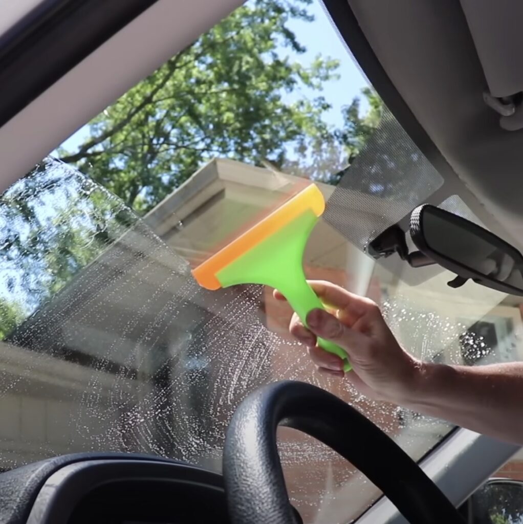 Guy demonstrates easy method to get inside of windshield squeaky clean ...
